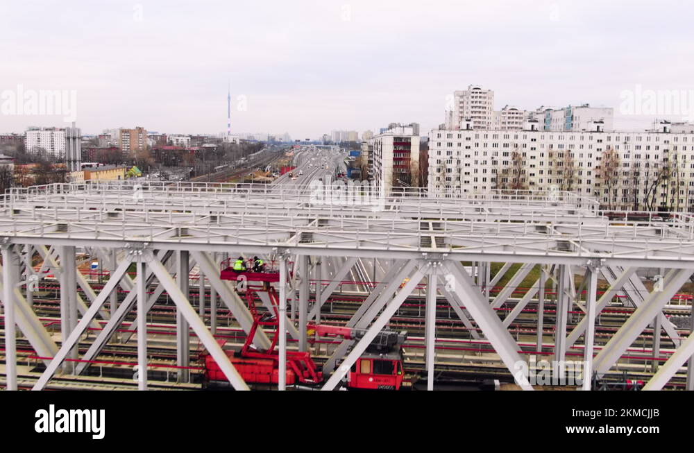 Railroad bridge. Train for construction. Workers lay new rails up view ...