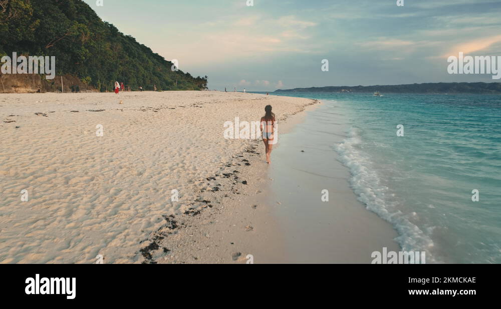 Woman run on morning tropical beach. Back view. Young beautiful girl in swimsuit Stock Video ...