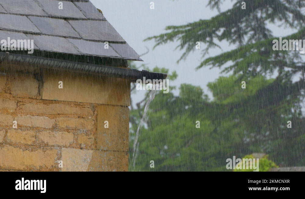 Gutter of old stone house leaking in the pouring rain Stock Video ...