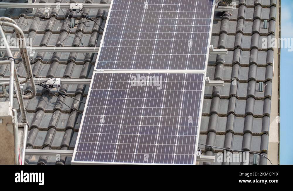 Sliding upward view of photovoltaic solar panels being installed on ...