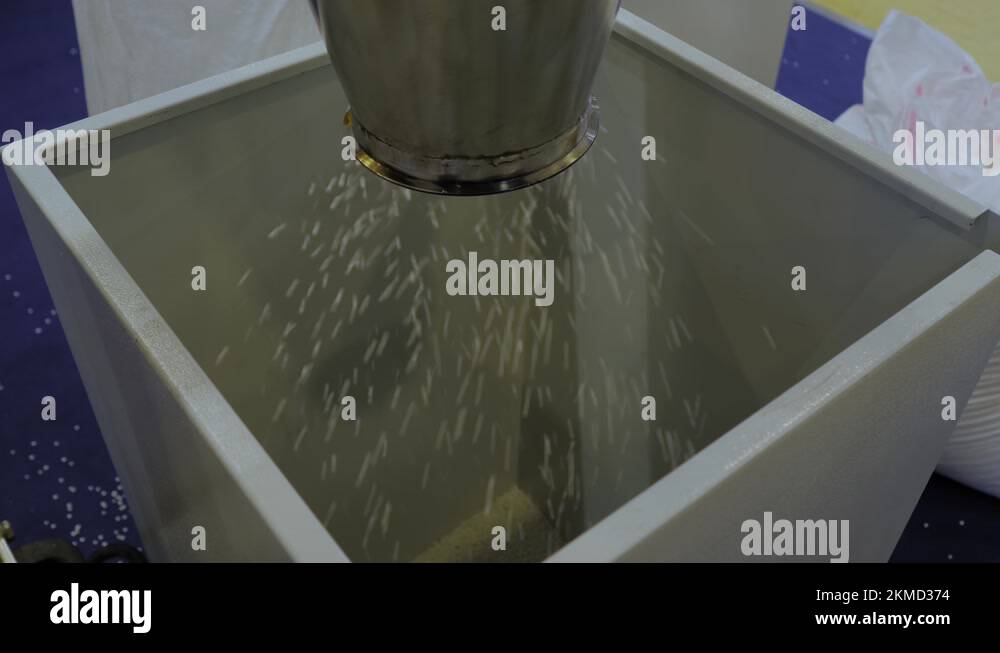 Recycled plastic granules, pellets falling in metal container at ...