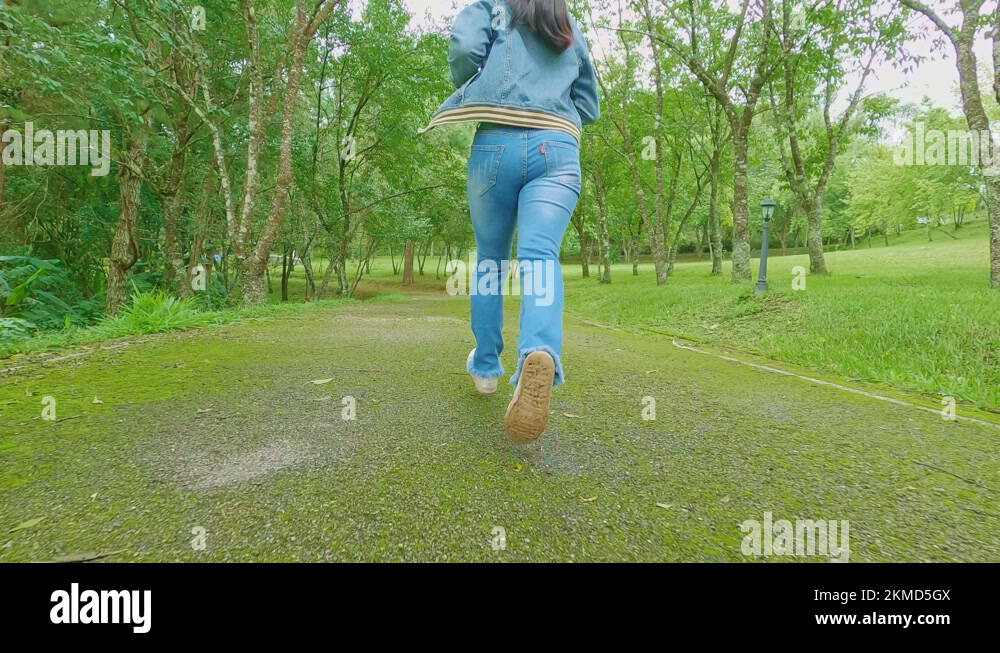 Steps feet of female tourist running on road with relaxed in the midst ...