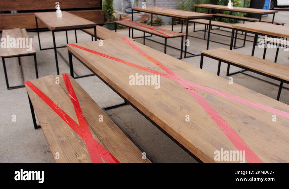 Empty cafe during Covid-19 lockdown.Tables with tape to keep social ...
