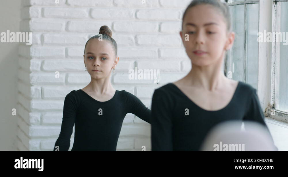 Young girls in dance class. Kids wearing leotards standing near window ...