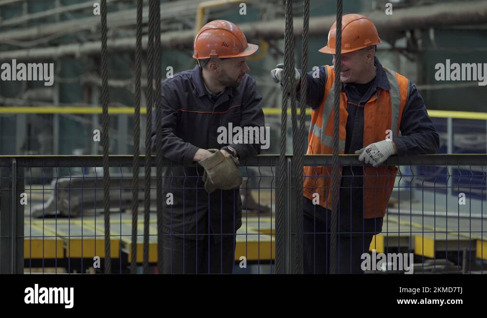Two Factory Workers Having a Break. Telling a Story and Laughing ...