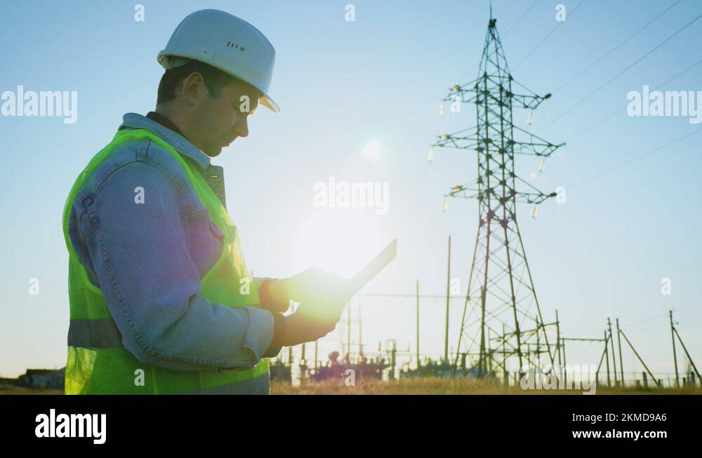Architect Worker Checking Construction Project On Electric Tower. One ...