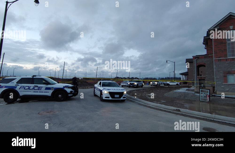 Police Man Lifting Up Crime Scene Tape for Police Cars Arriving at ...