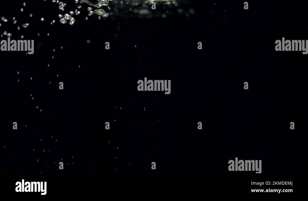 Slow motion air bubbles in water rising up to surface on black ...