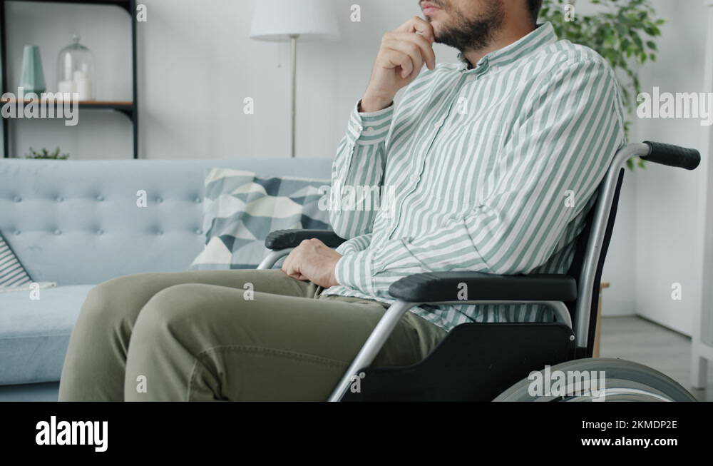 Portrait of lonely disabled guy sitting in wheelchair with sad face ...