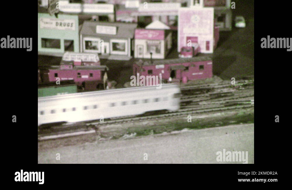 1960s: Model trains run on a track on display in a store. Boy watches ...
