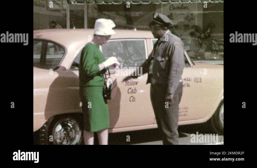 1960s: Taxi driver opens cab door for woman. She pays him. Man in diner ...