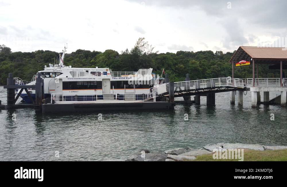 White passenger boat at the terminal waiting for onboarding passenger ...