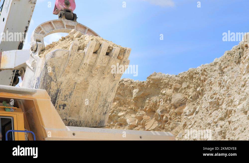 An excavator and a truck dig and load the construction soil. Excavator ...