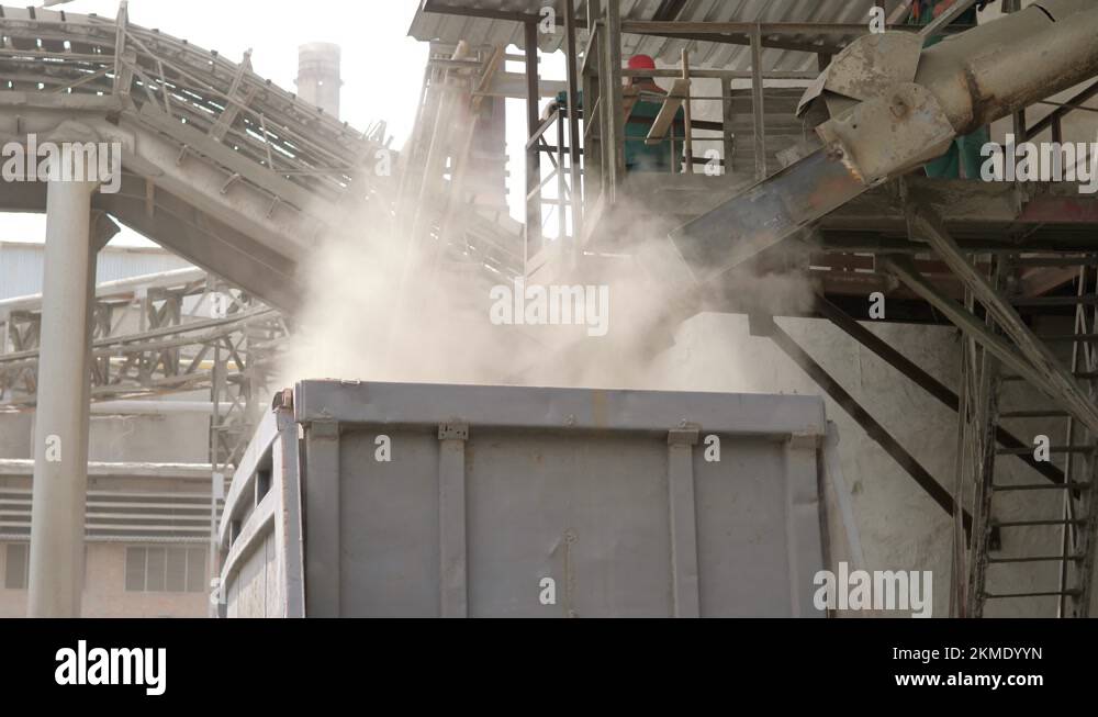 A freight train is moving along the rails at the factory, and stones ...