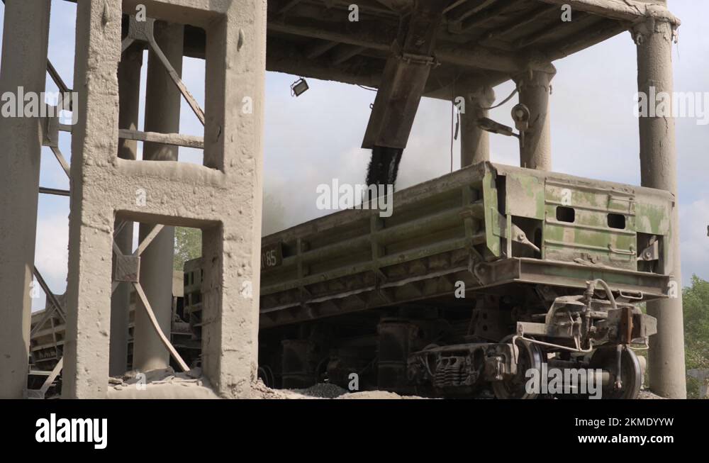 A freight train is moving along the rails at the factory, and stones ...