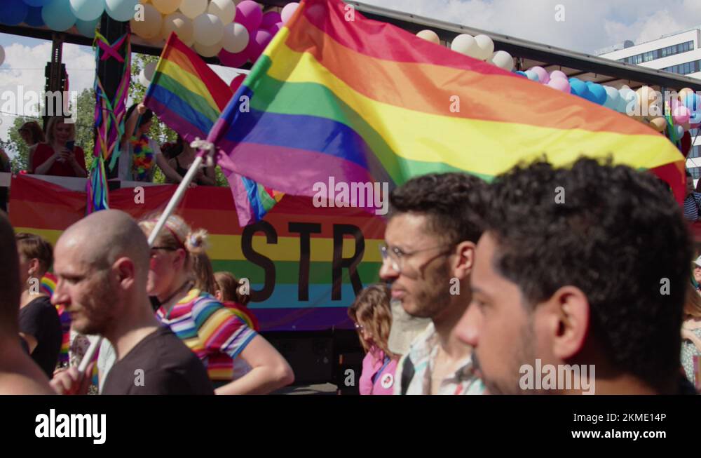 Caravan on LGBTQ pride parade, people with angel rainbow colored wings ...