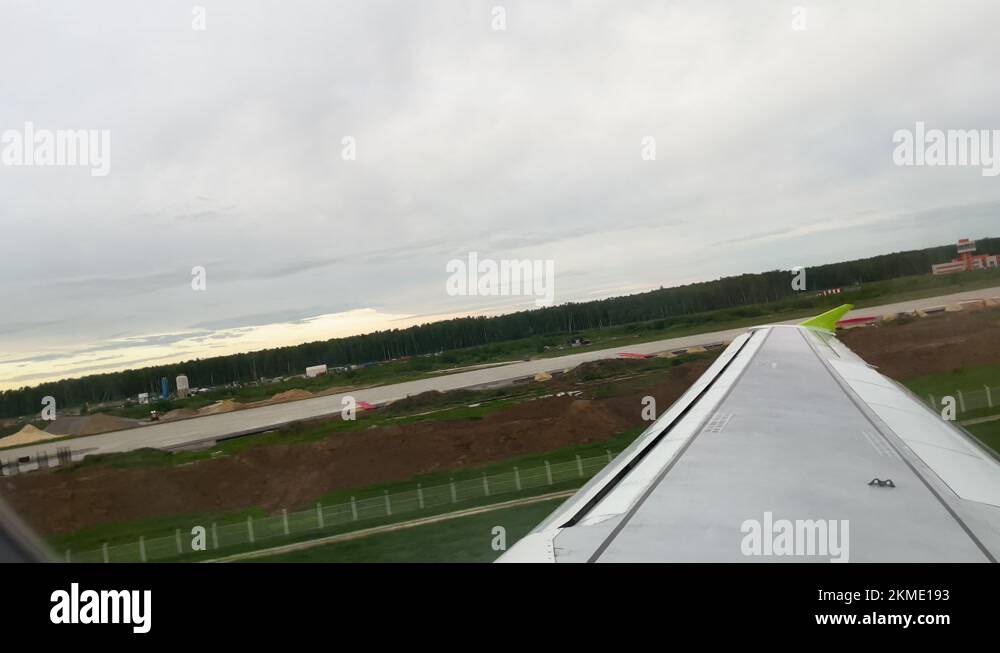 View from window an airplane taking off at the airport. Air transport ...