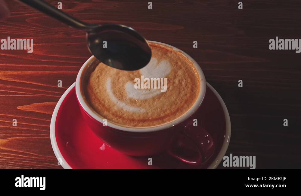 POV shot of spoon getting in coffee cup and mixin coffee then Stock ...