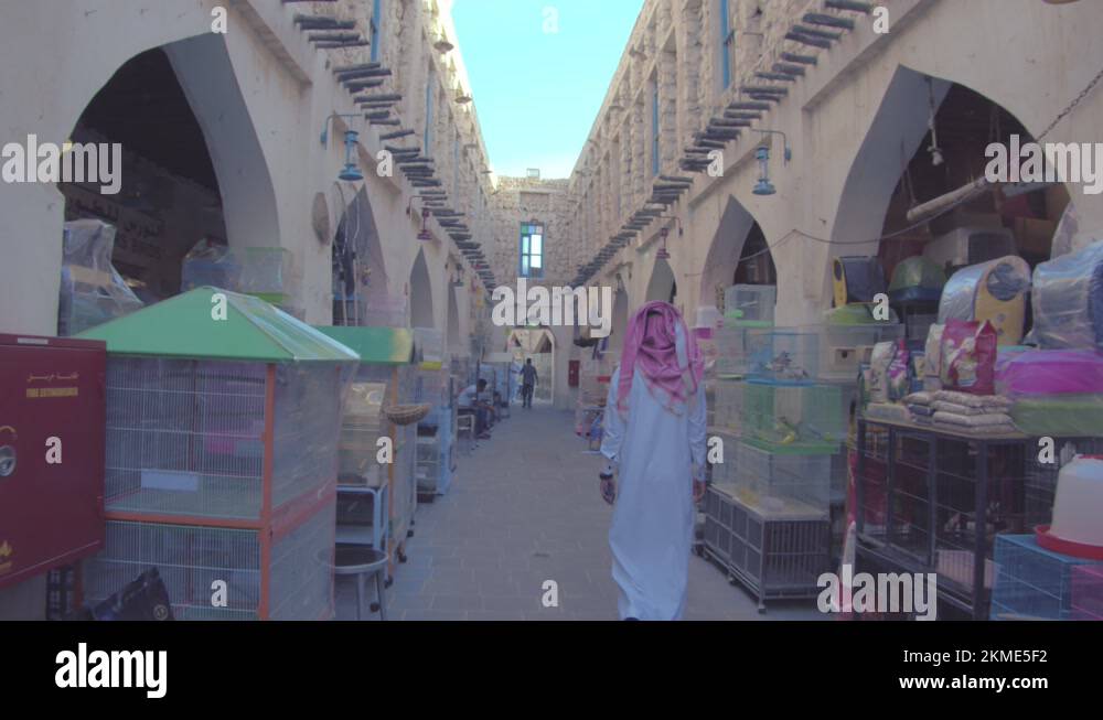Back View Of An Arab Man In White Thawb And Agal Passing By A Pet Shop ...