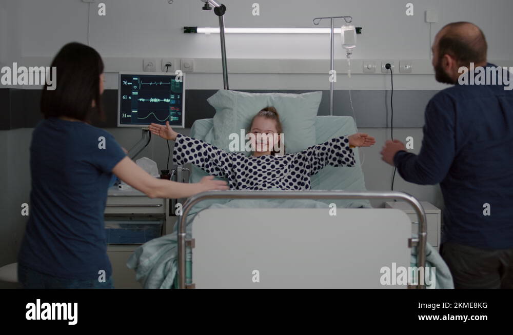 Sick girl patient with oxygen nasal tube resting in bed recovering ...