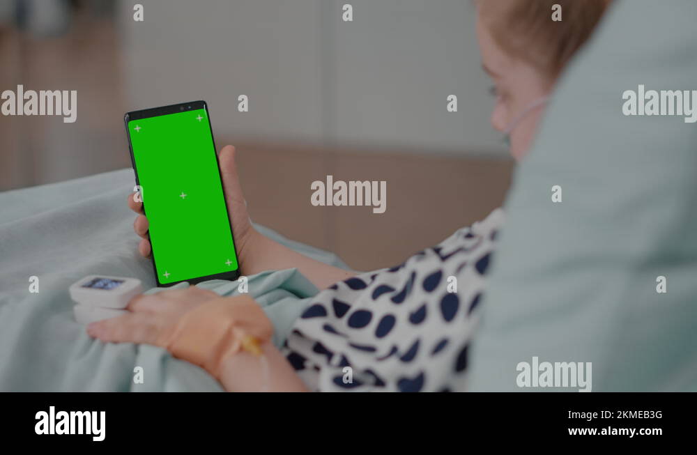 Sick girl resting in bed with medical oximeter on finger looking at ...