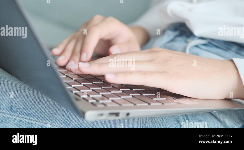 Texting on laptop keyboard close up side view, person typing on ...