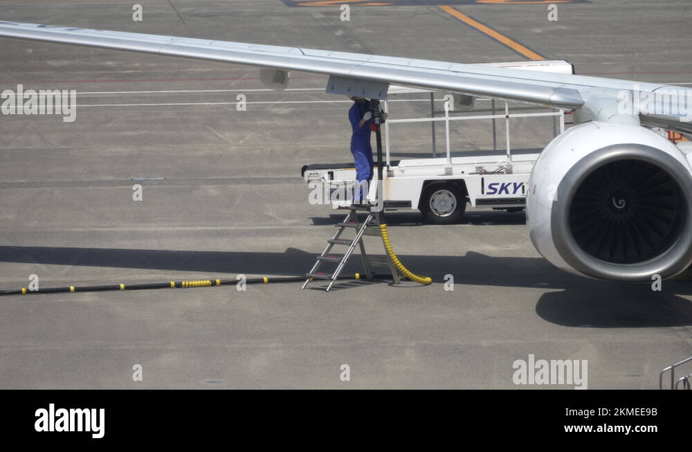 Refueling Boeing Airplane - Ground Crew Attaches And Connect Hose To ...