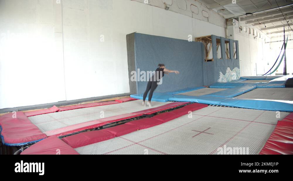 Trampoline gymnastics, young woman is jumping and doing flips, 4k Stock ...