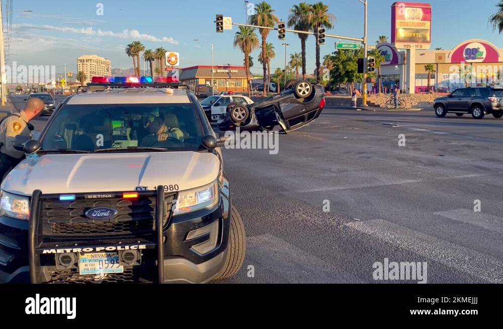 Police vehicle pulling up to rollover crash Stock Video Footage - Alamy
