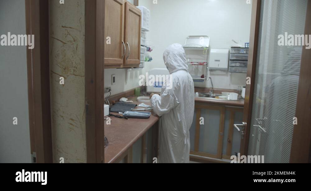 Medic with a coverall labeling a sample in a laboratory Stock Video ...