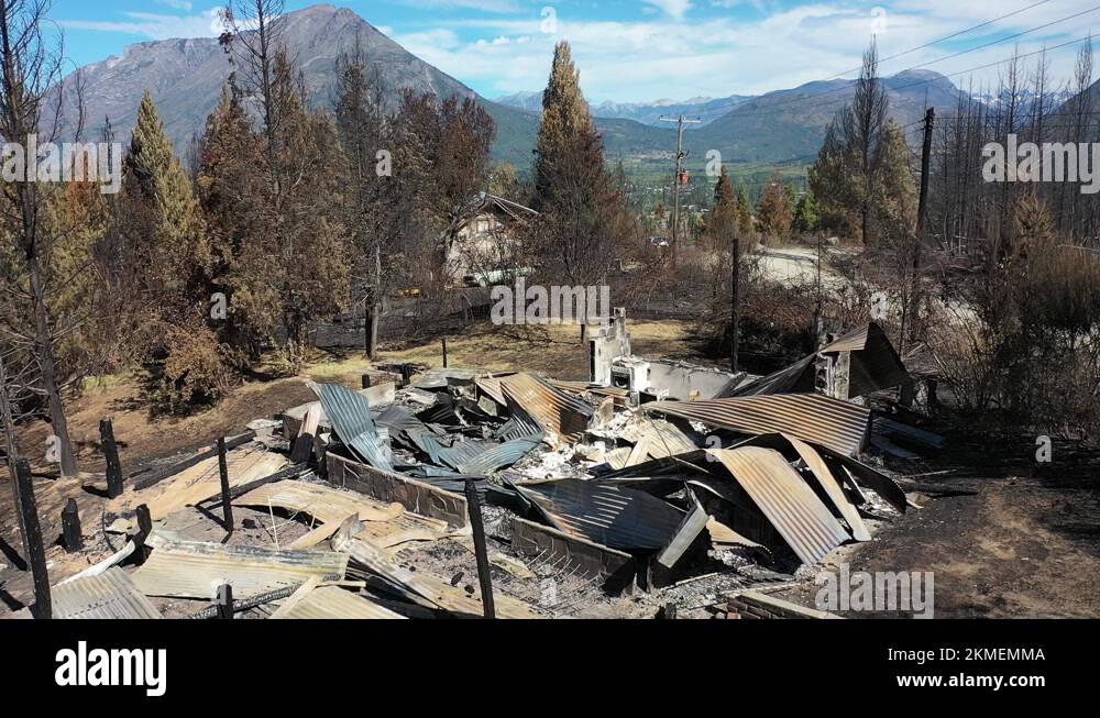 Camera fly and tilt down to a house destroyed by fire. Aerial forward ...