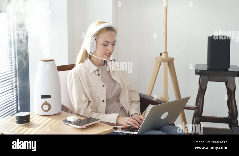 Working at home, smart working. Female uses laptop and modern devices ...