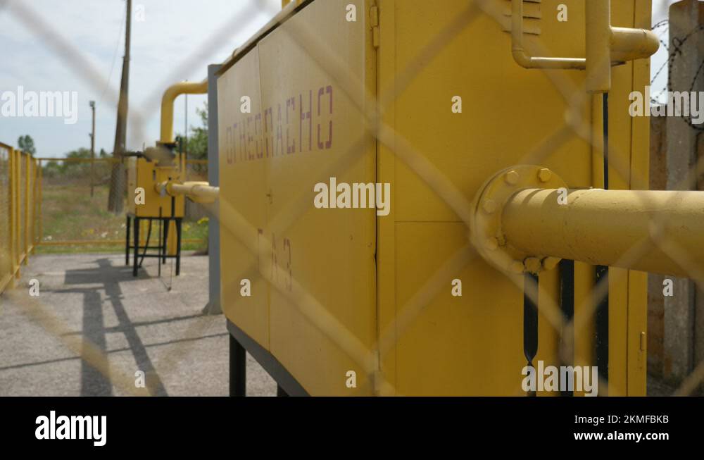 Gas station behind the metallic web with tubes and yellow boxes ...