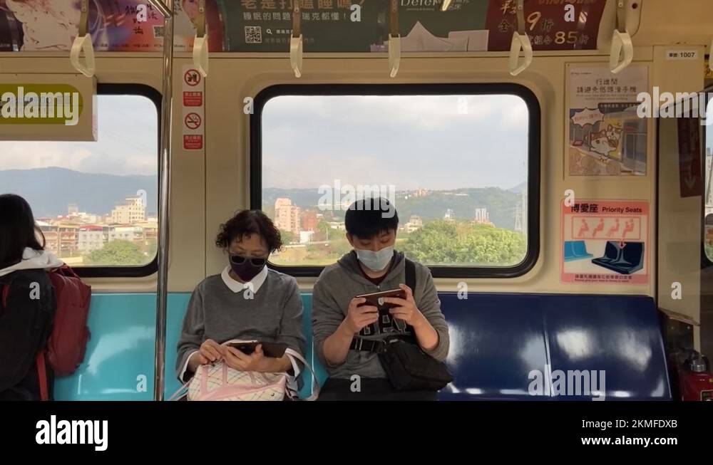 Passengers on public transport MRT train wearing face mask during Covid ...