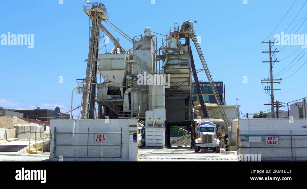 Conveyor belt pouring concrete into mixer truck at industrial cement ...