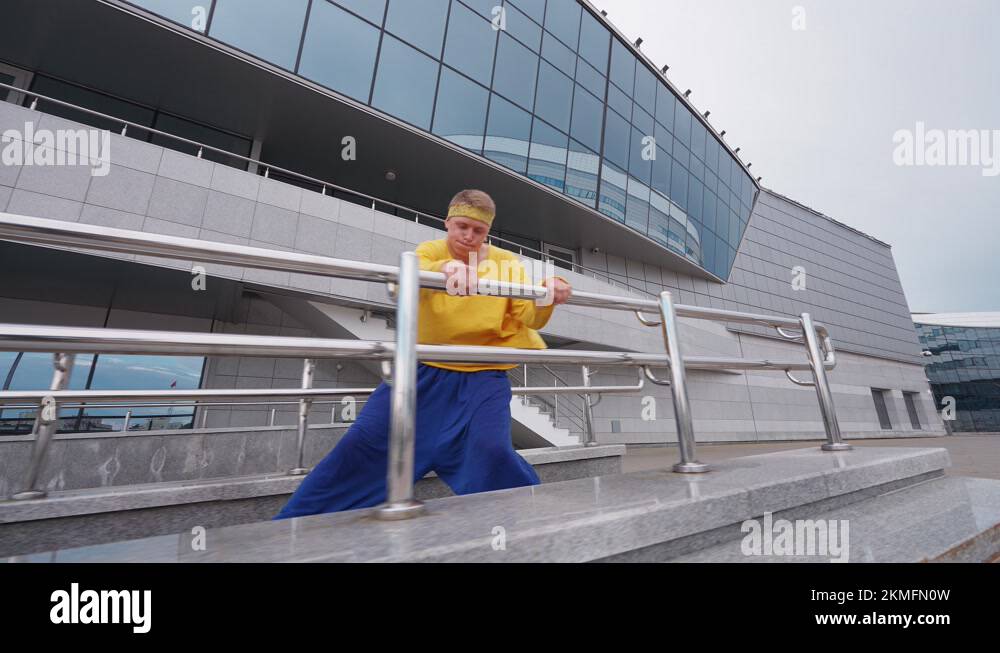 Free running, young man runs over obstacles in the city and doing a ...