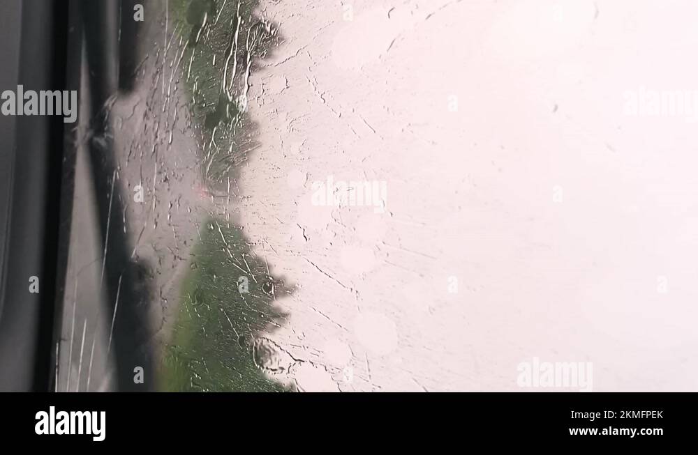 Driving in torrential rain. Rain hits the windshield. Inside view of ...