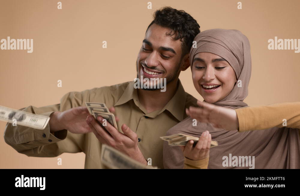 Rich Muslim Couple Throwing Money Posing Over Beige Studio Background ...