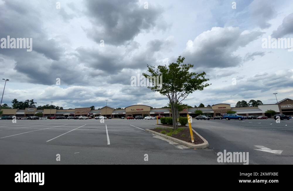 Pan of a busy urban strip mall shopping center on a cloudy day Roses Beauty s Stock Video ...