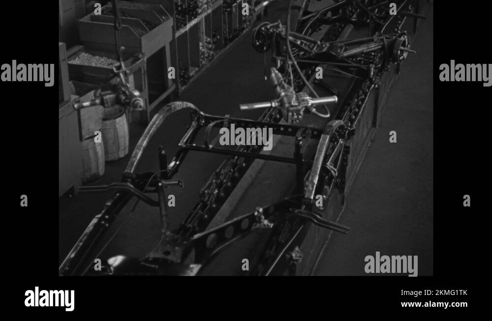 1940s: Car chassis sit idle on assembly line in empty automotive ...