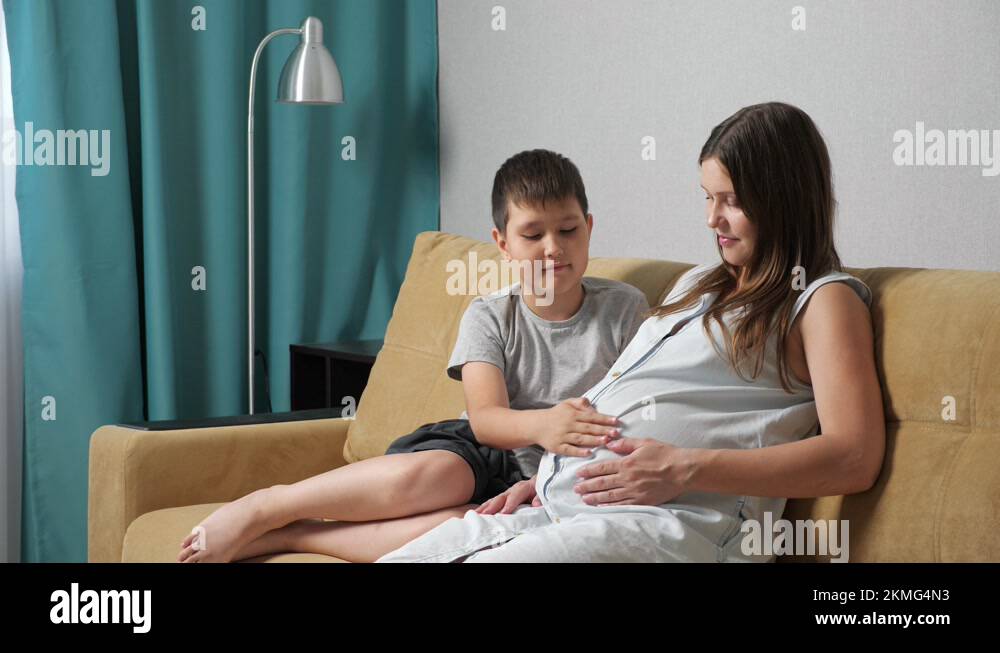 Pregnant Mom And Son On The Couch Boy Stroking And Hugging Belly Stock 8484