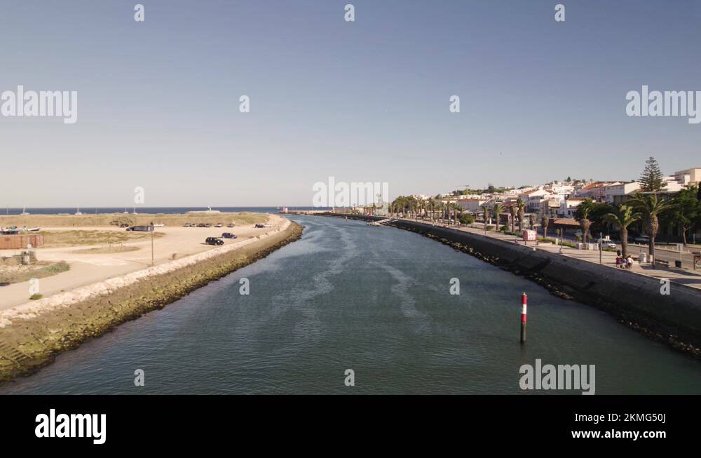 Fly-over Bensafrim estuary flow along promenade into Lagos coast ...