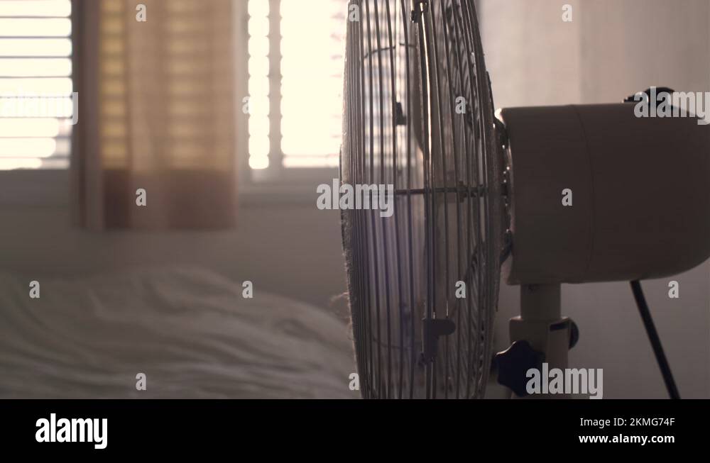 Dusty Electric air fan turned on. Close up of hand switching on ...