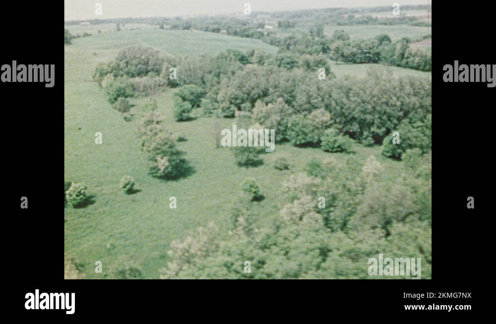 1970s: Aerial view from air of meadows, trees and farms on monarch ...