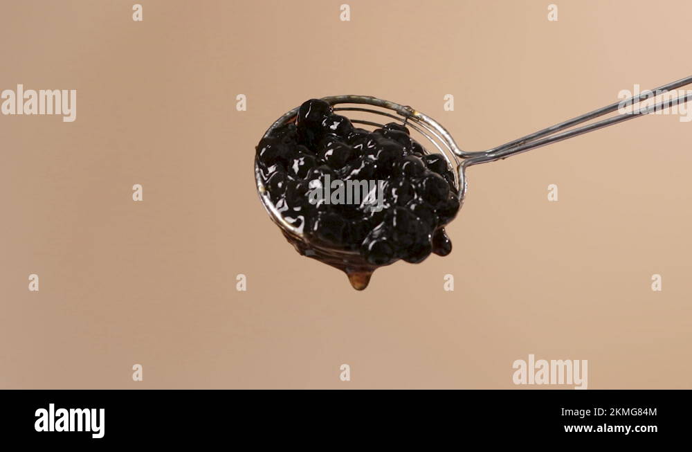 Juicy Black Tapioca Pearls Slowly Falling from Round Spider Strainer ...