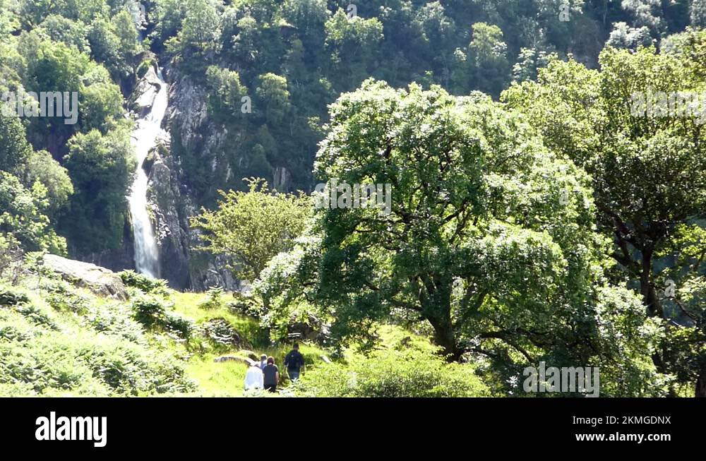 People hiking Aber falls Snowdonia mountain Welsh national park ...