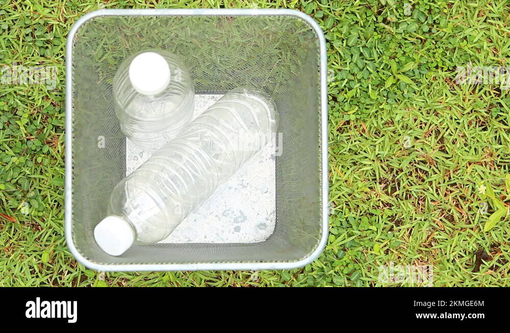 Man throwing plastic water bottles in to the bin out door Chiangmai ...