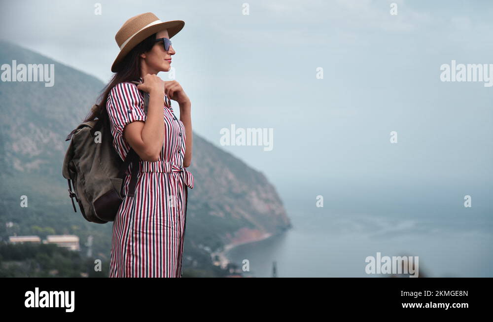 Backpacker tourist lady admiring natural scenery from top on high ...