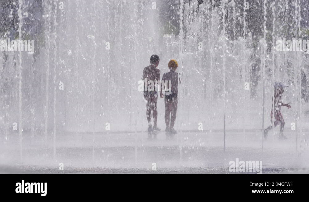 Silhouettes, Kids Having Fun Between Water Splash in Fountain on Street ...