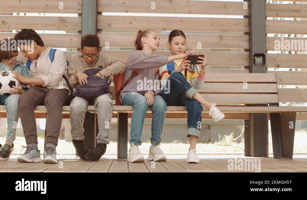 School children sitting on bench Stock Videos & Footage - HD and 4K ...